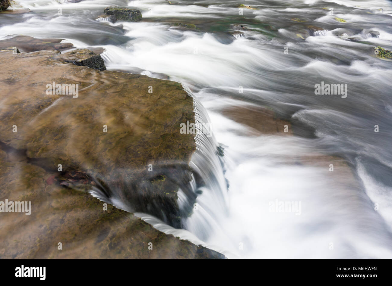 Smooth flowing river Stock Photo - Alamy