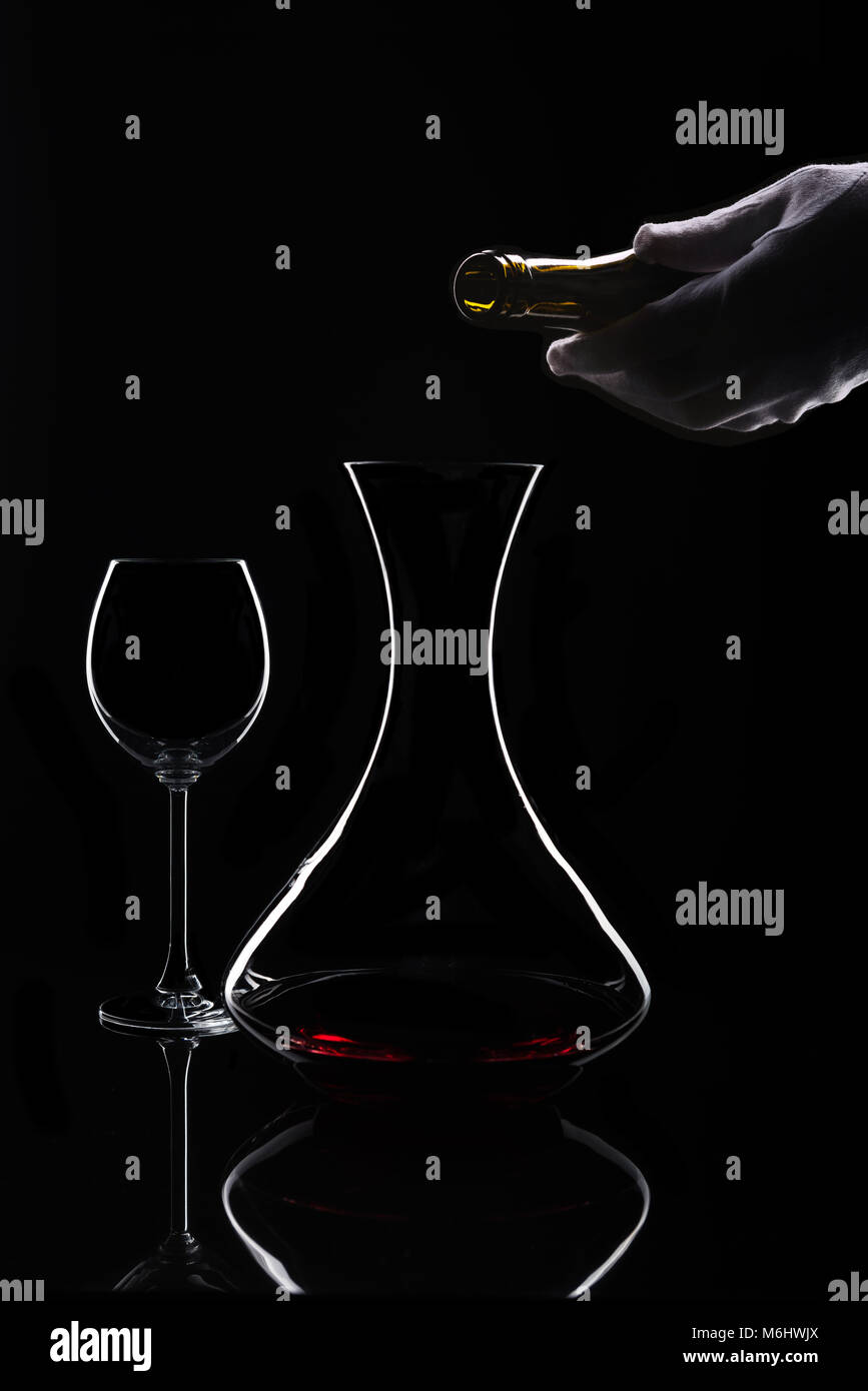 Red wine decanting process at isolated black Stock Photo - Alamy