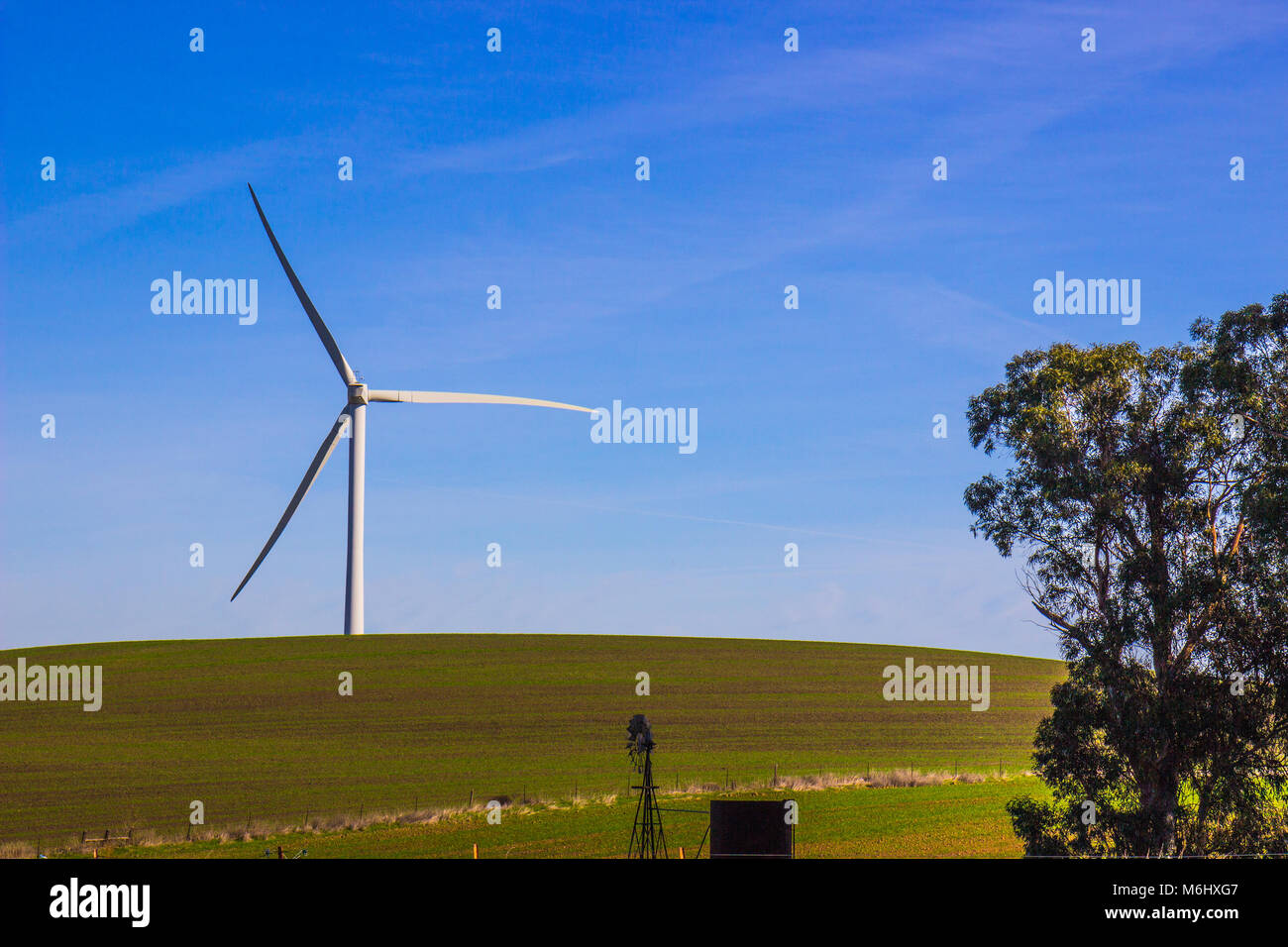 Three Bladed Energy Producing Windmill On Grassy Knoll Stock Photo - Alamy