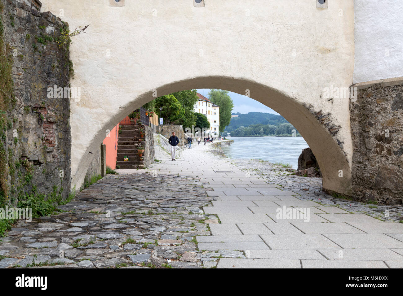 Stone arch over cobblestone pedestrian street. A popular path along the ...