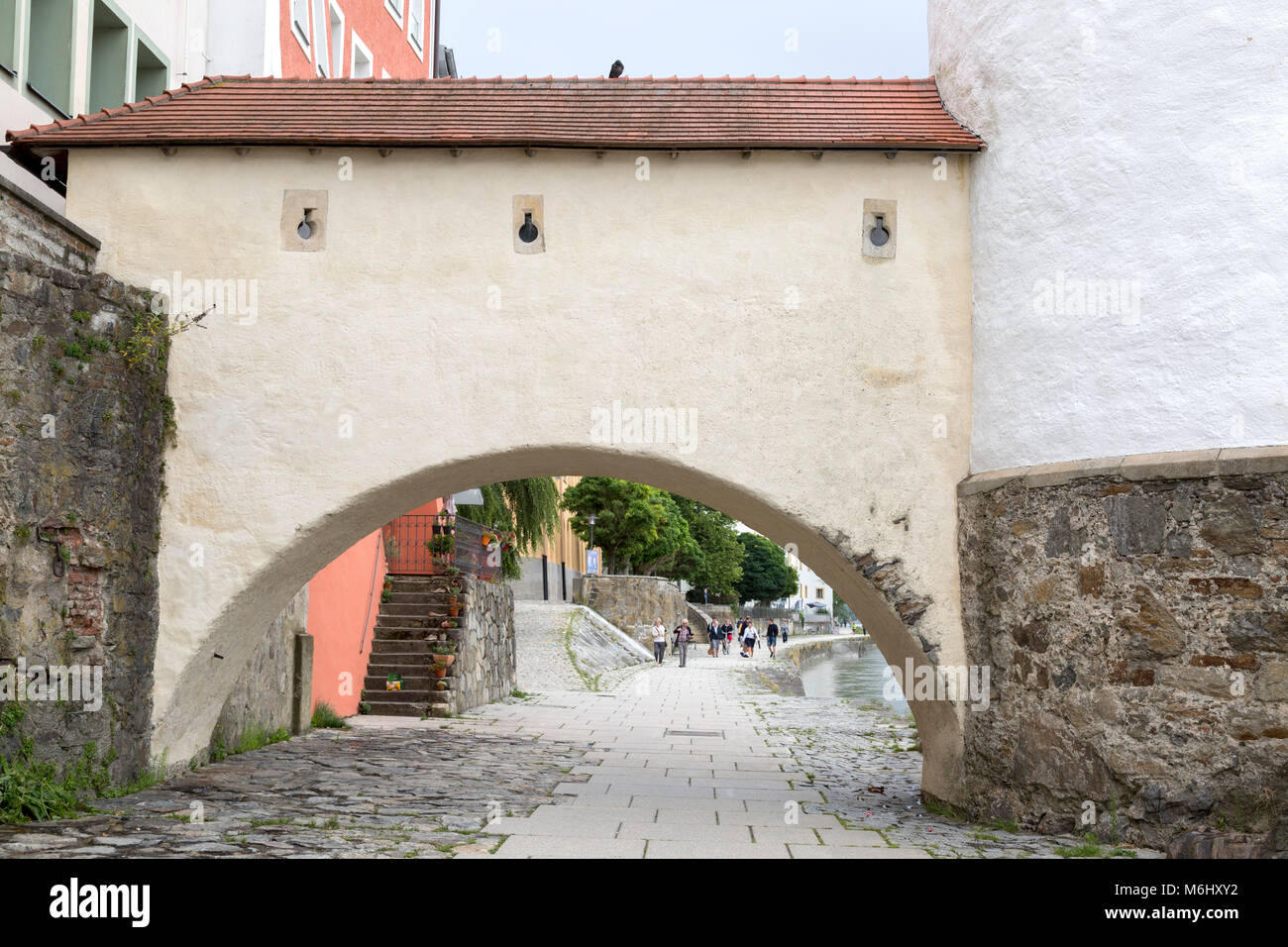 Stone arch over cobblestone pedestrian street. A popular path along the ...