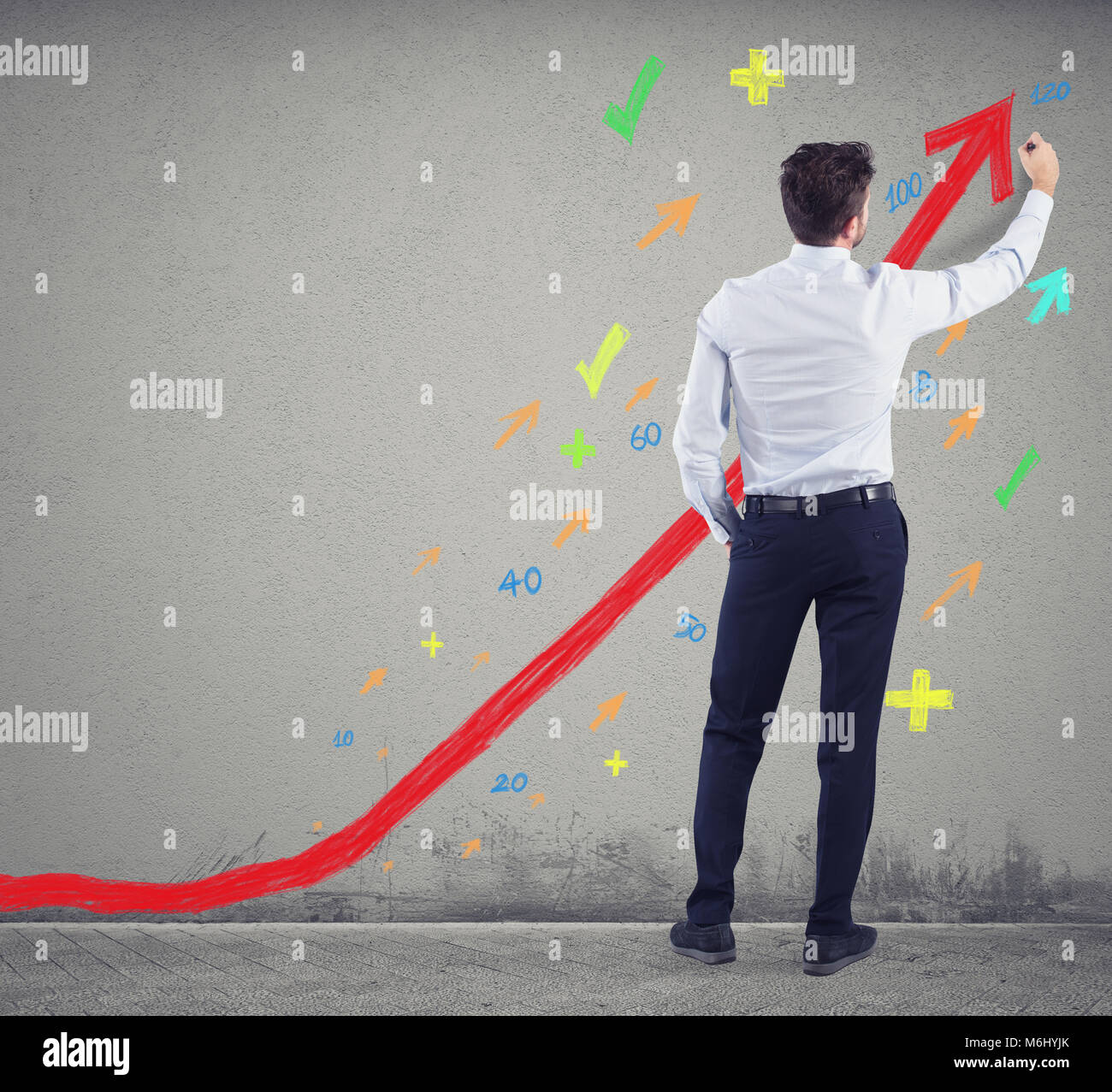 Businessman draws positive statistics of his company. Concept of ...