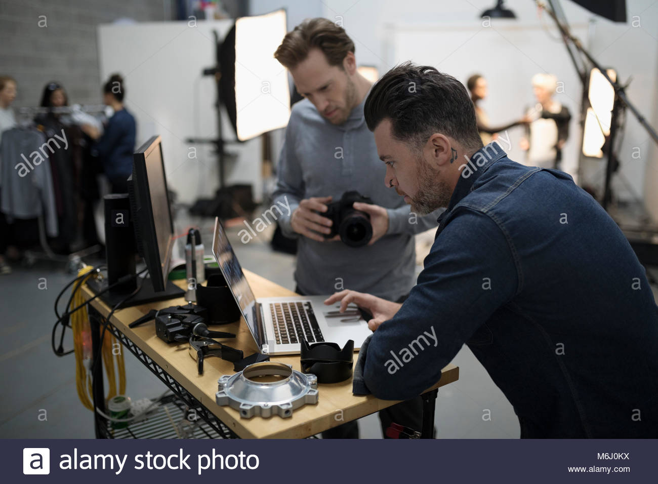Photographer and production team preparing photo shoot in studio Stock ...