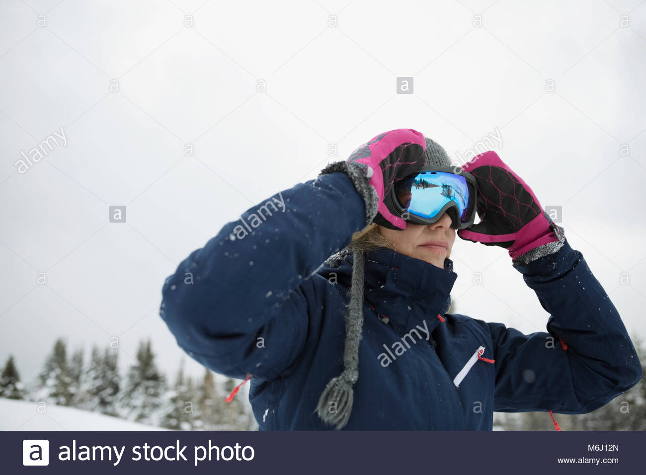 Female skier adjusting goggles Stock Photo - Alamy