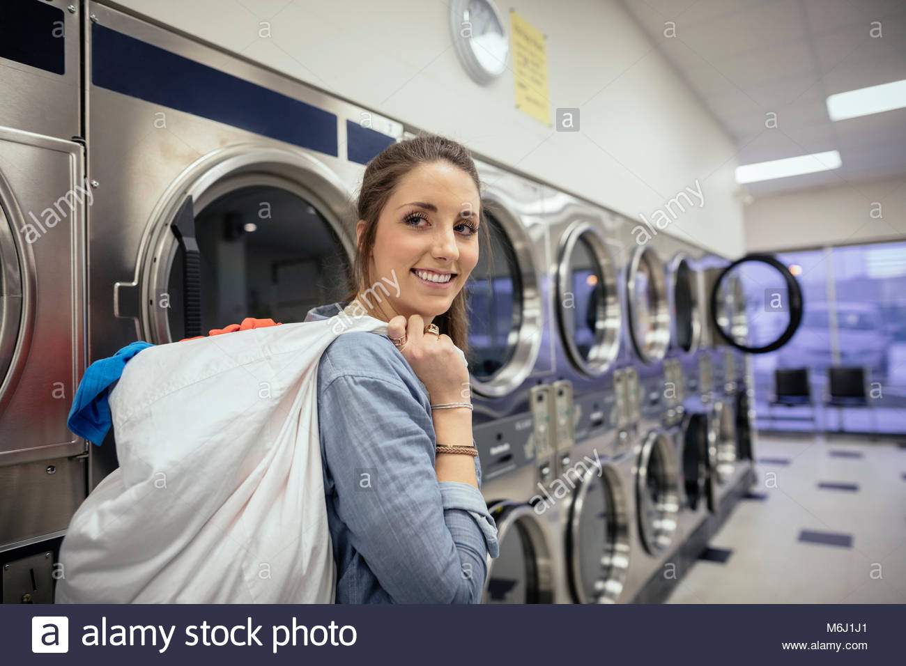 Person carrying laundry bag hi-res stock photography and images - Alamy