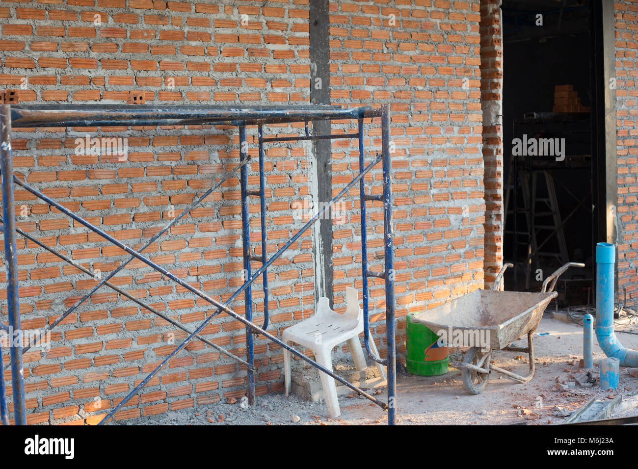 Brick wall and partition with construction device Stock Photo - Alamy