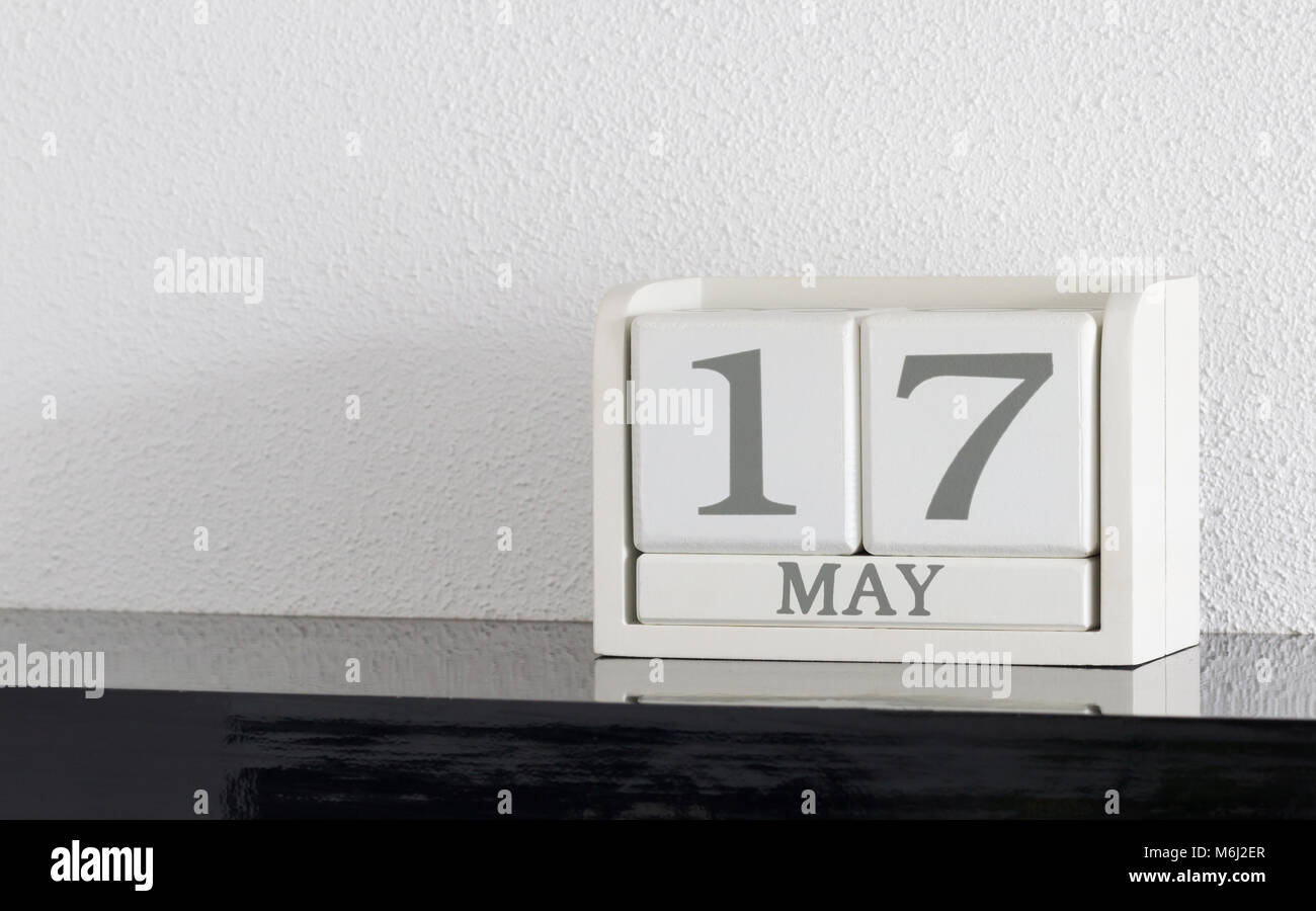 White block calendar present date 17 and month May on white wall ...