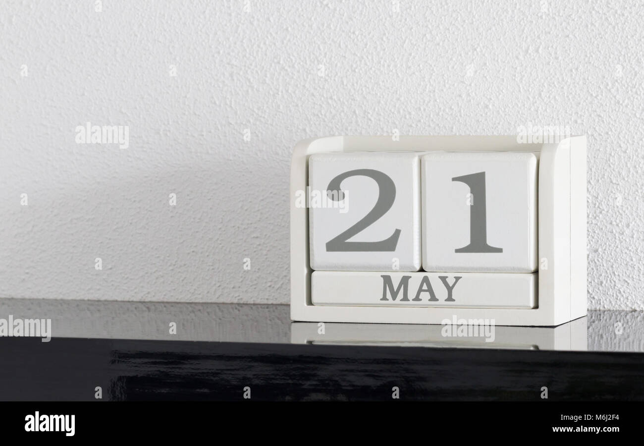 White block calendar present date 21 and month May on white wall ...