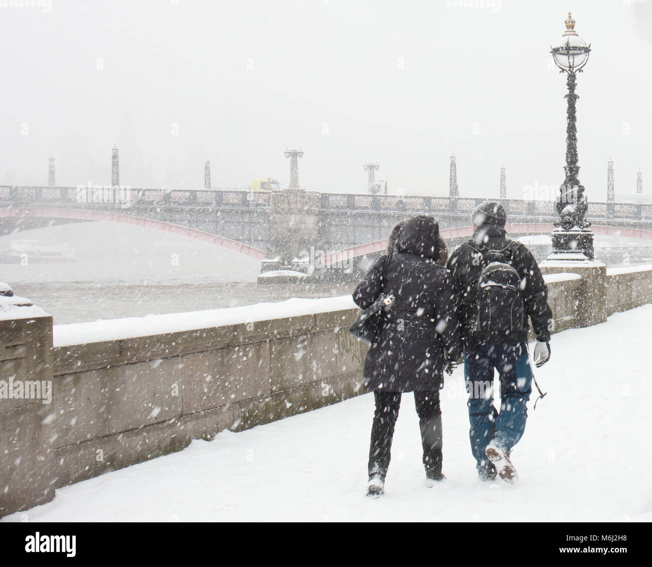 Couple Walking in Heavy Snow along the Albert Embankment in London ...
