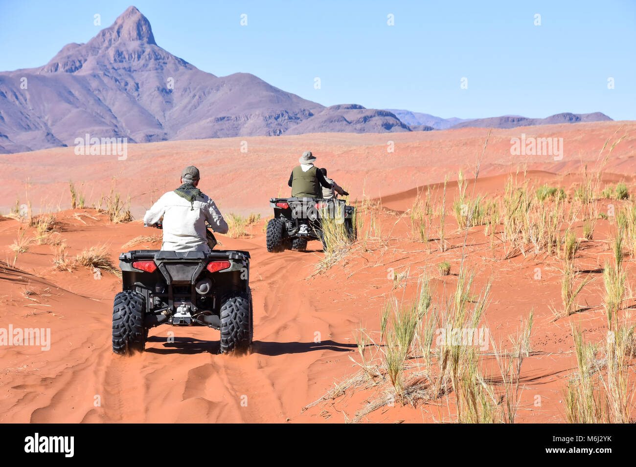 Tourists quad biking in the sossusvlei desert in Namibia Southern ...