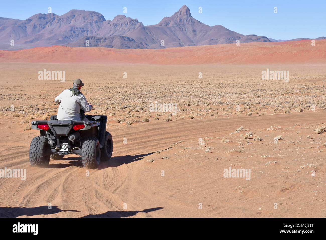 A tourist quad biking in the sossusvlei desert in Namibia Southern ...
