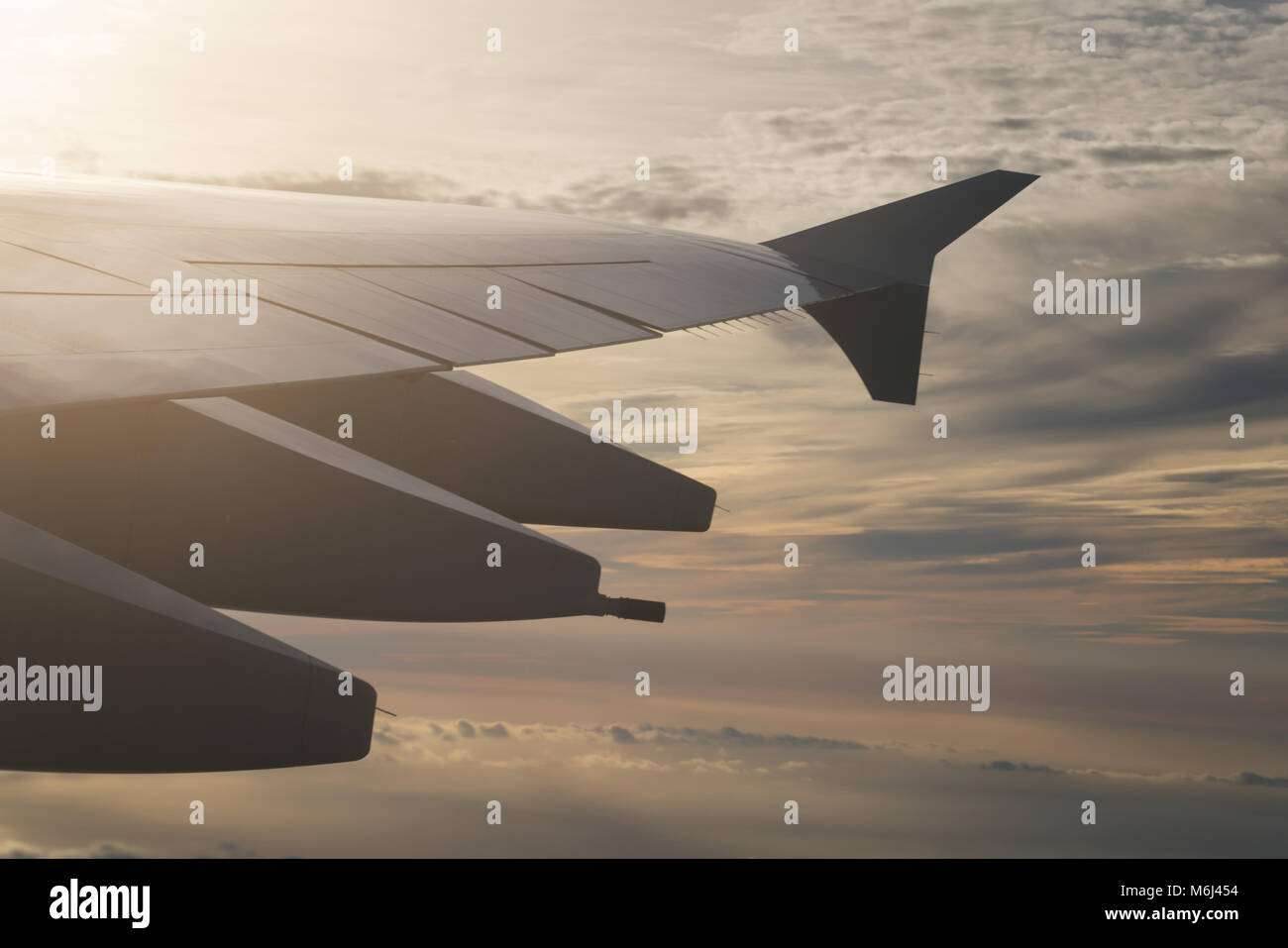 view of airplane wing during flight in sunset Stock Photo - Alamy