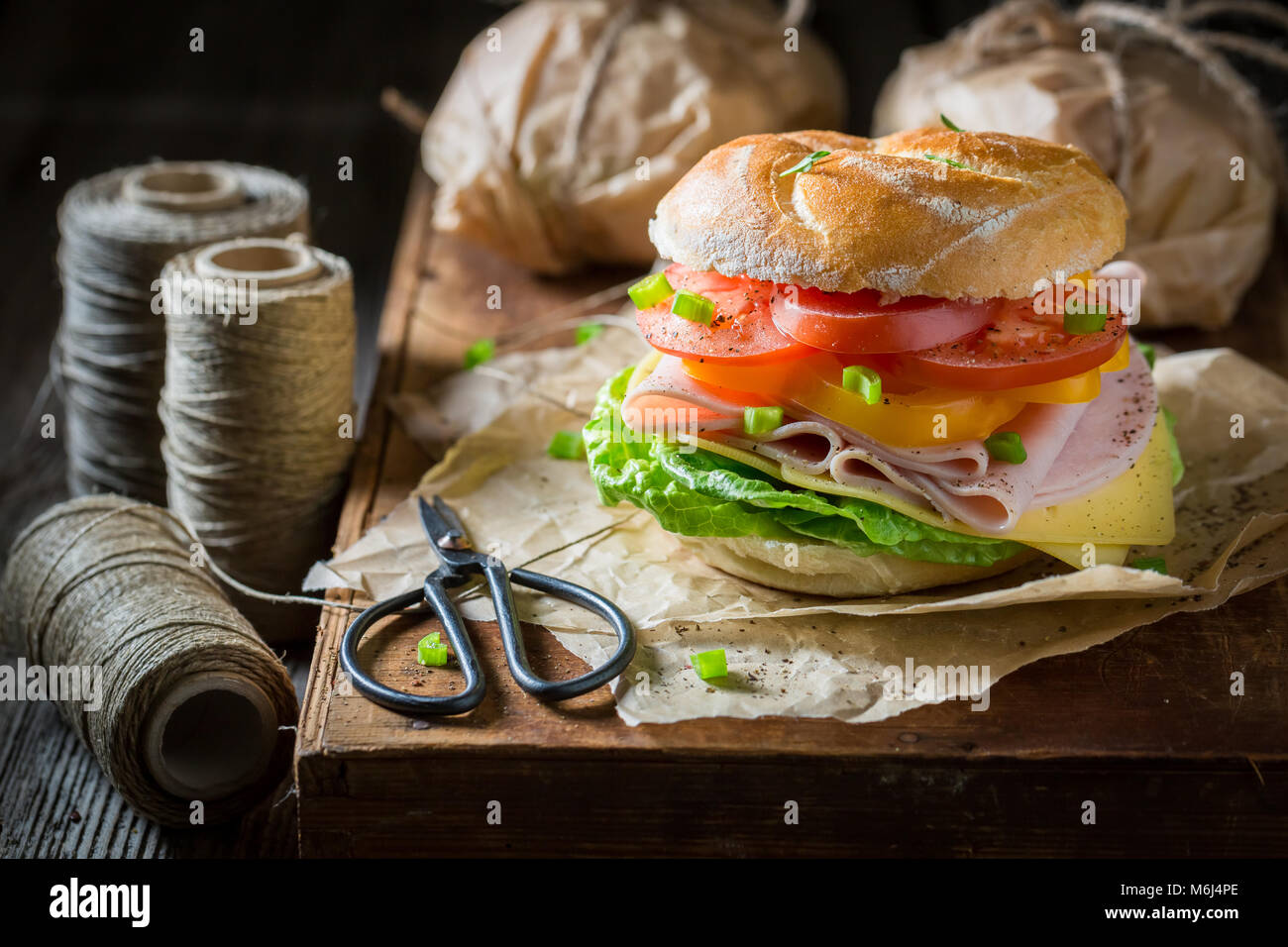 Delicious take away sandwich packed in a gray paper Stock Photo - Alamy