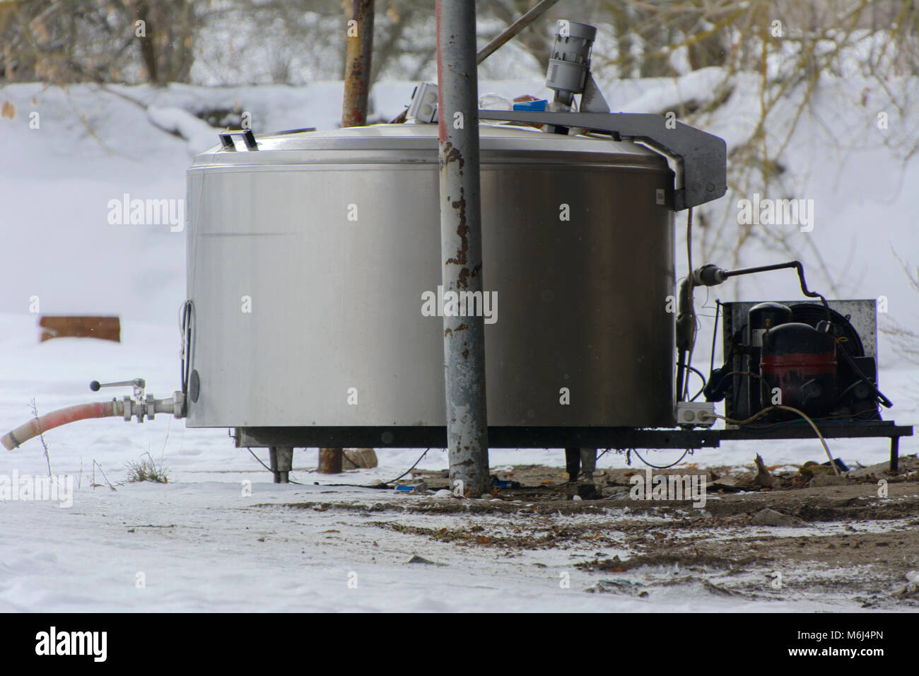 A large old tank for collecting milk in an abandoned and destroyed ...