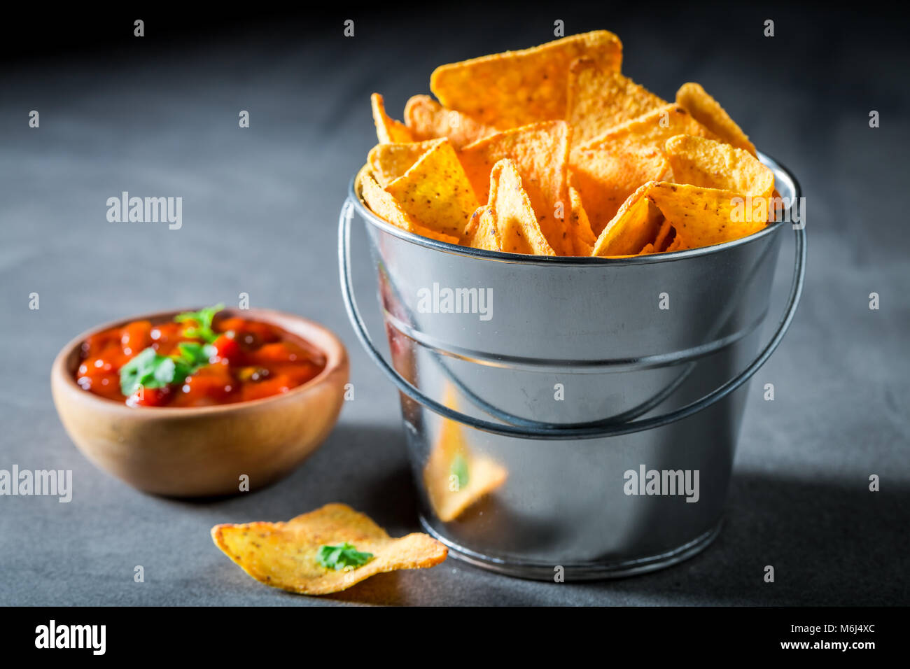 Crispy nachos with spicy red sauce and salt Stock Photo - Alamy