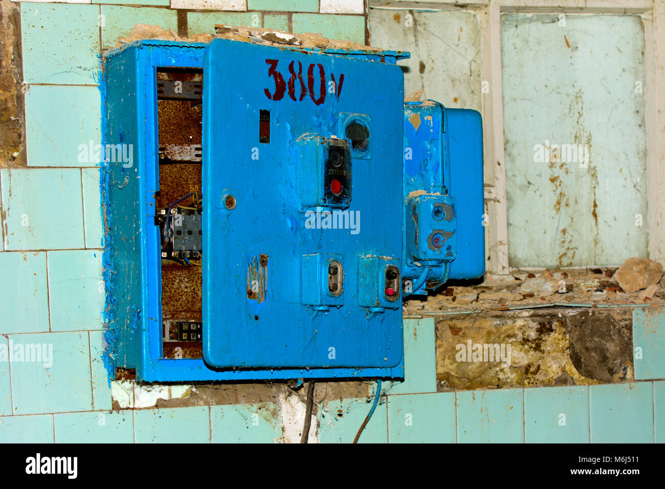 Old dismantled and rusty electrical panel assembly on an abandoned and ...