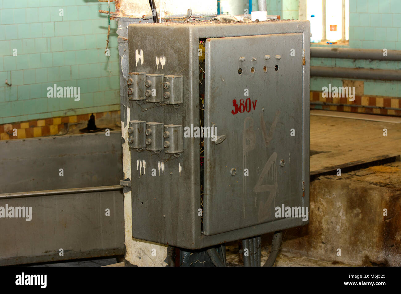 Old dismantled and rusty electrical panel assembly on an abandoned and ...