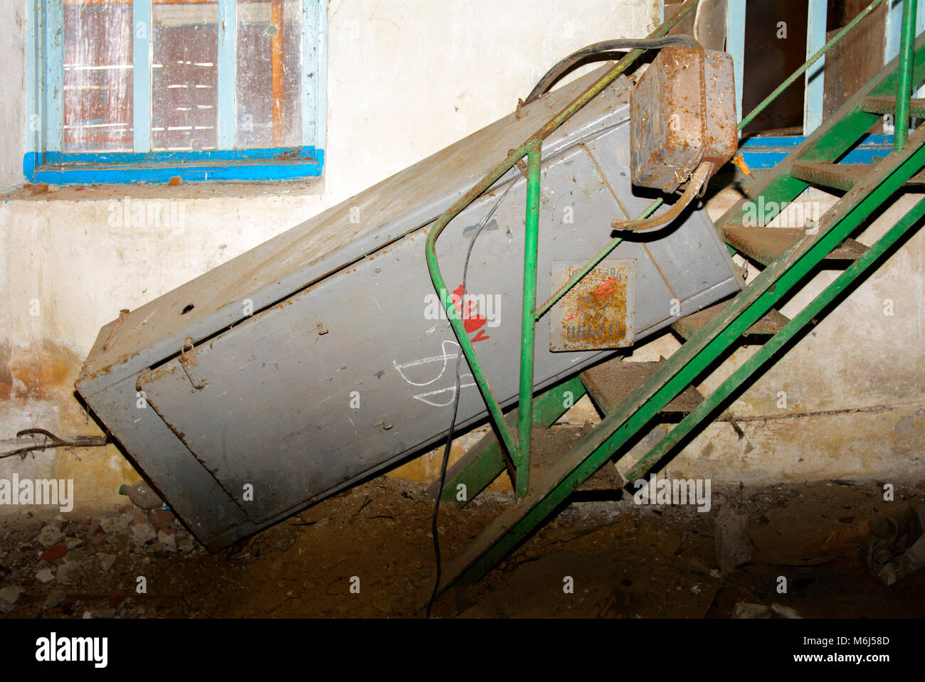 Old dismantled and rusty electrical panel assembly on an abandoned and ...