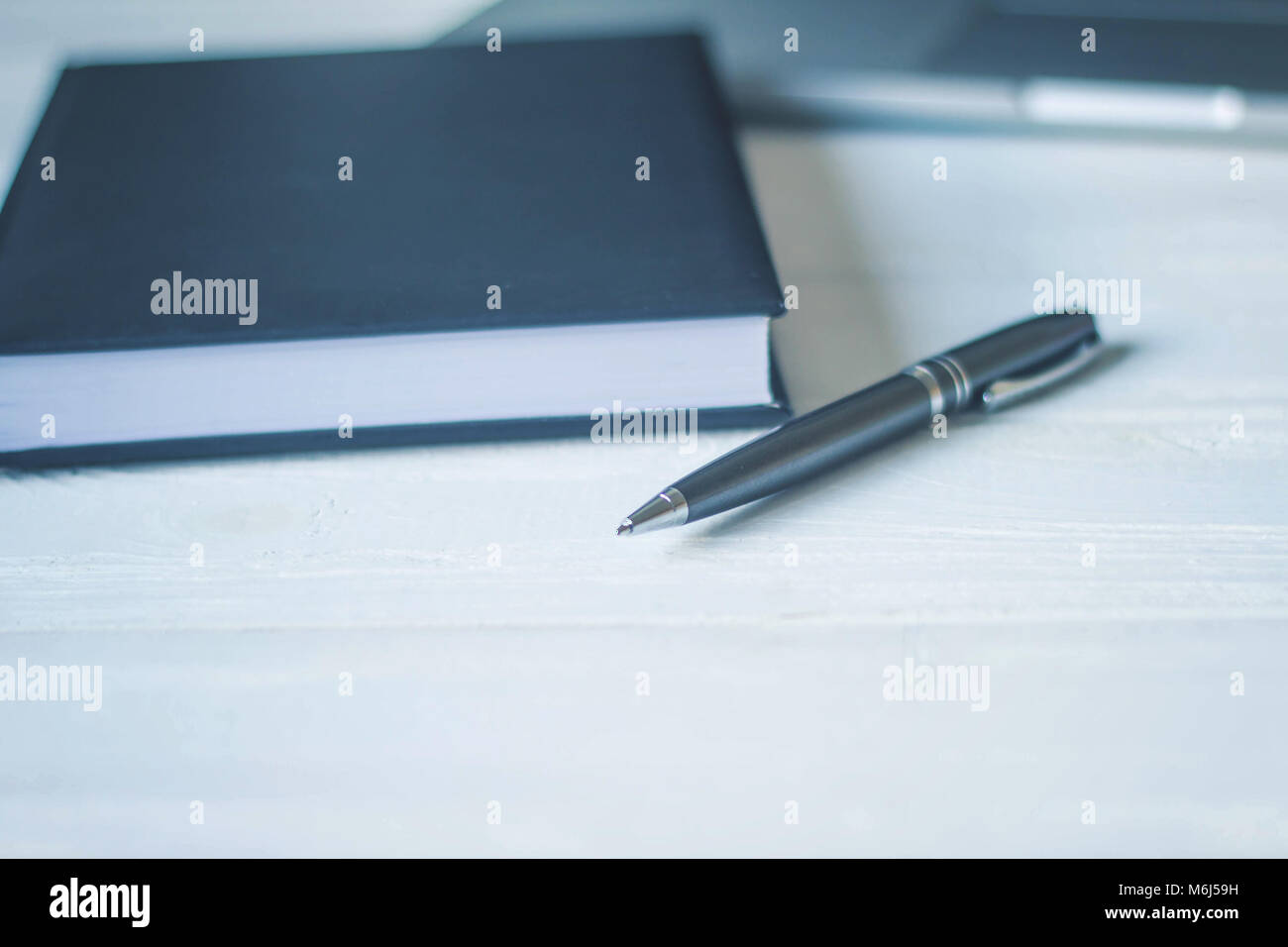 pen and a notebook at the workplace Stock Photo - Alamy