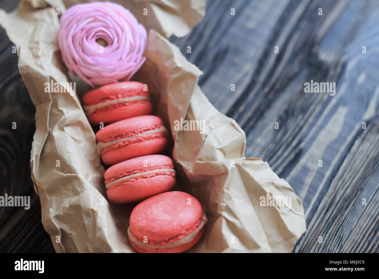 Colorful macaroons and flowers on table Stock Photo - Alamy
