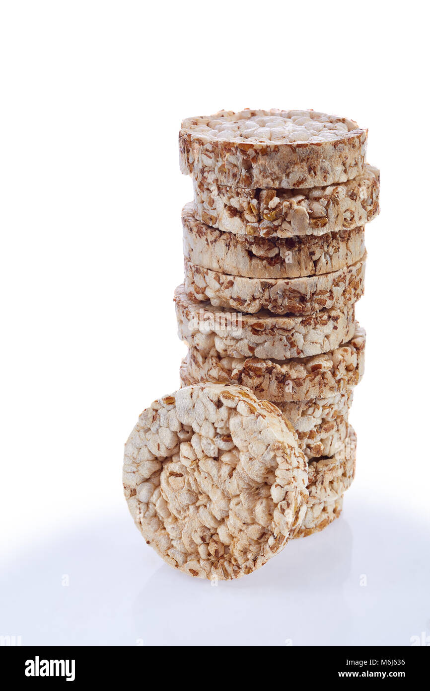 Round wheat crispbread, white background. Composition of grain ...