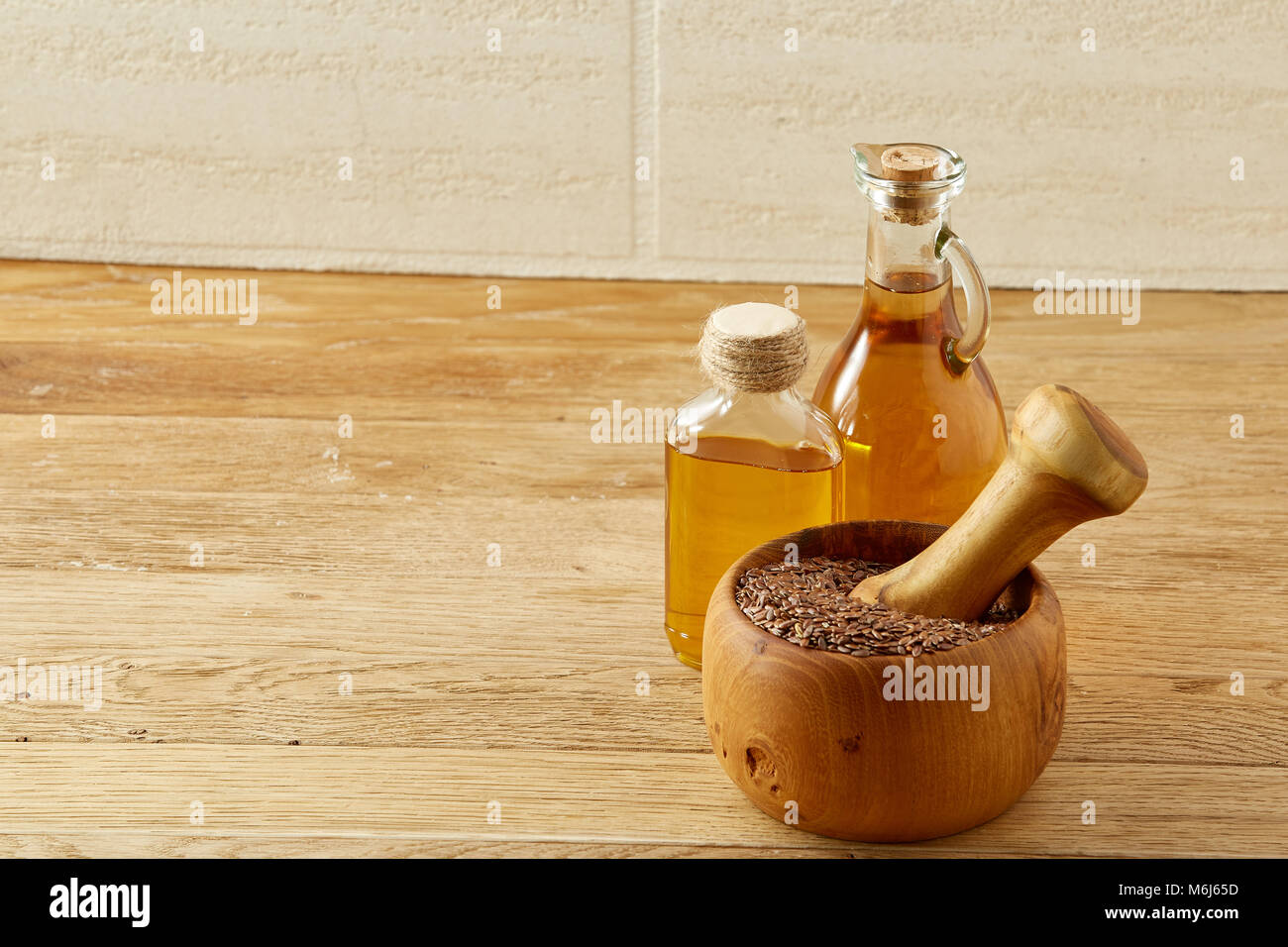 Beautiful composition of two transparent glass oil jars, wooden mortar ...