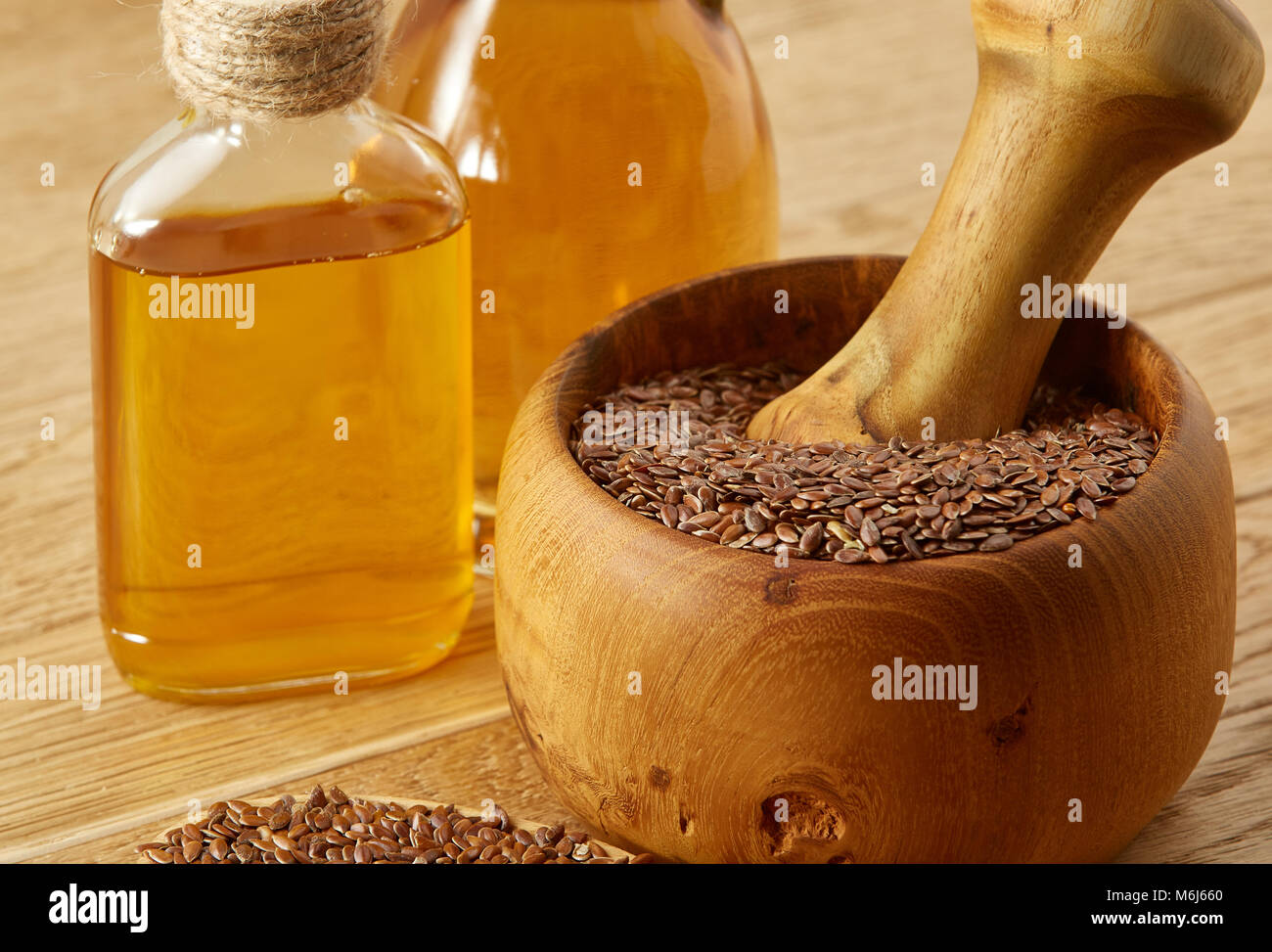 Beautiful composition of two transparent glass oil jars, wooden mortar ...