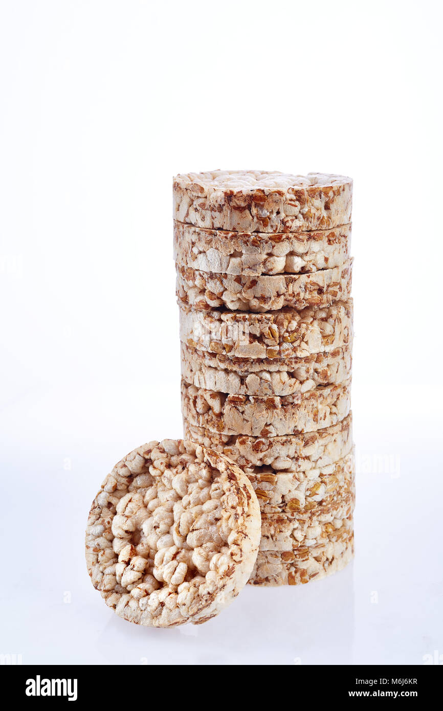 Round wheat crispbread, white background. Composition of grain ...