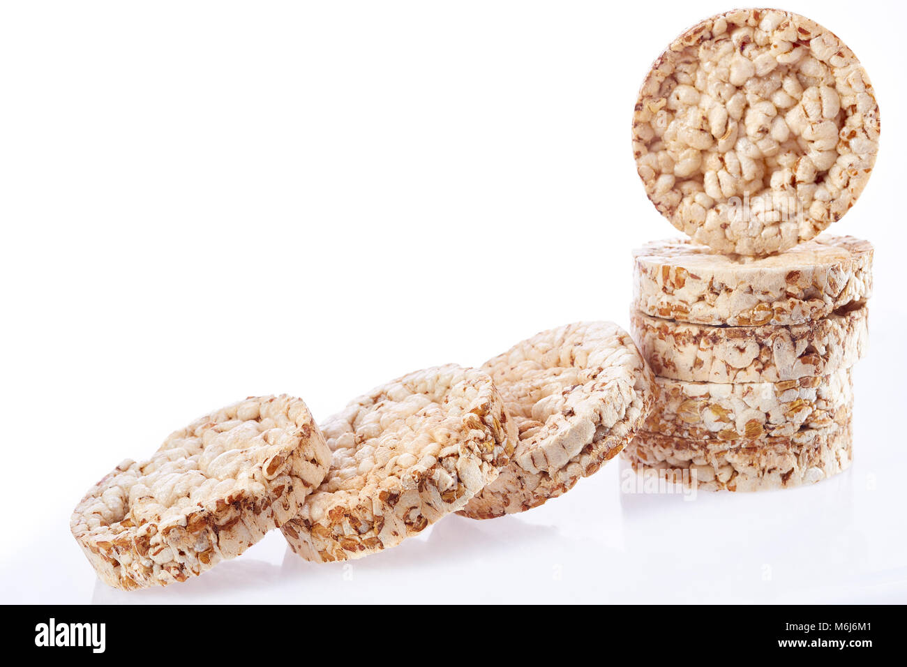 Round wheat crispbread, white background. Composition of grain ...
