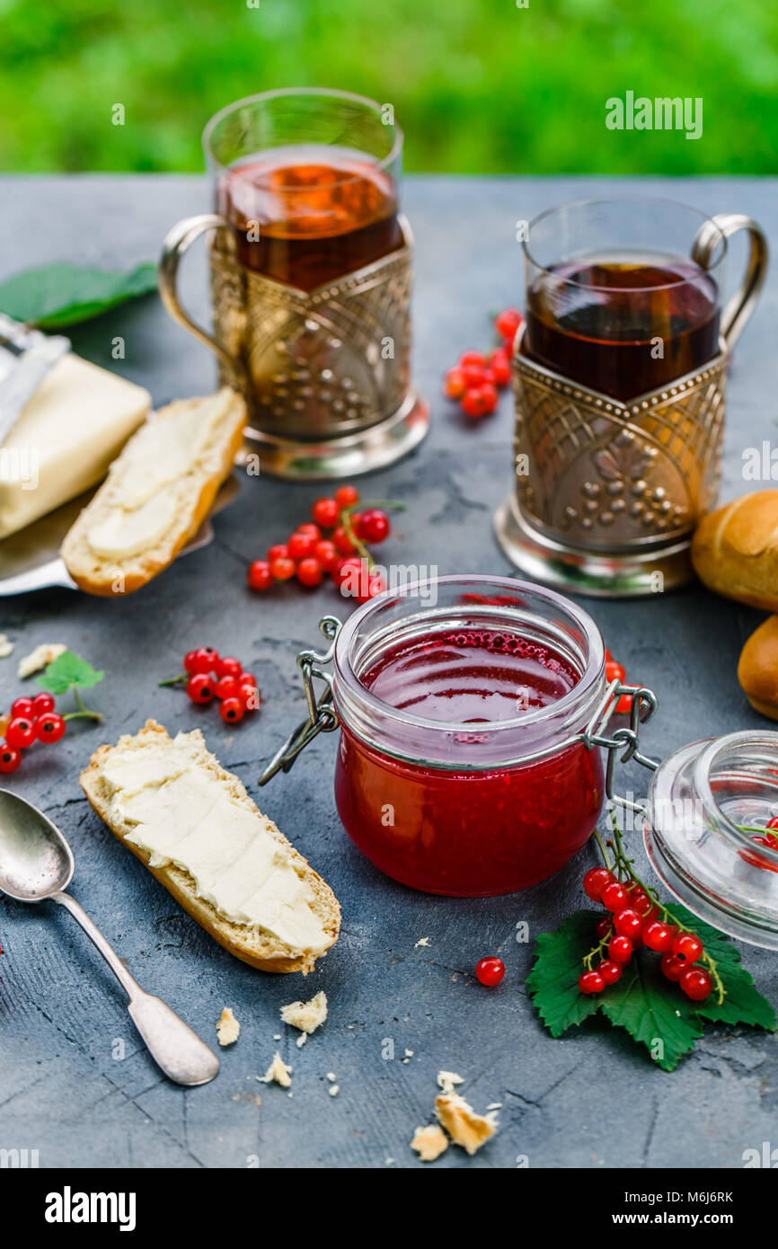 Red currants and jar of jam in garden Stock Photo - Alamy