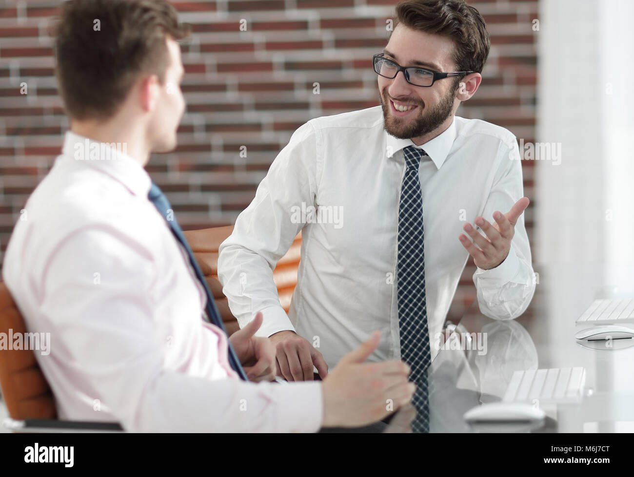 Manager talking with a colleague Stock Photo - Alamy