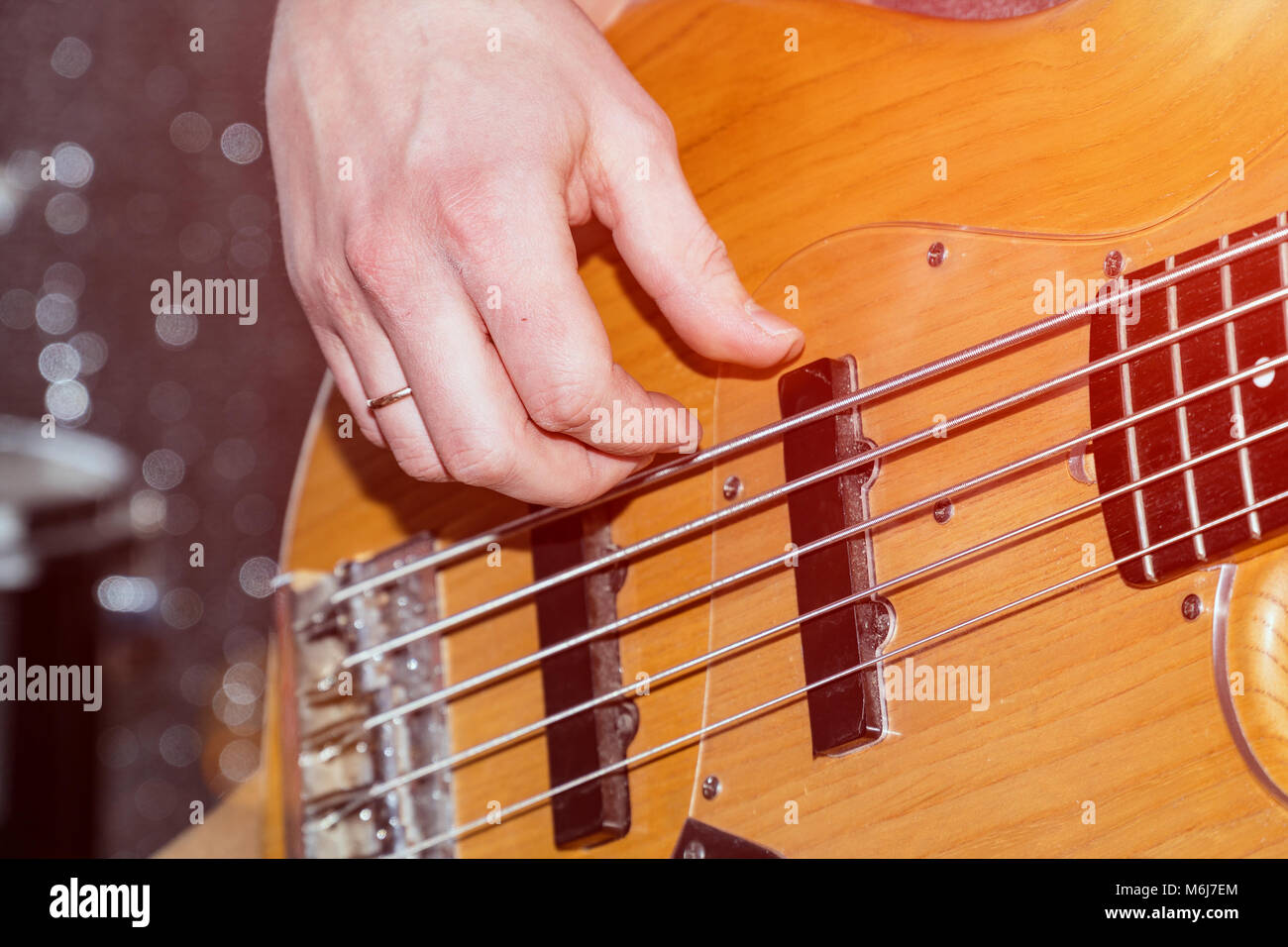 Hands of the guitarist's bass Stock Photo - Alamy