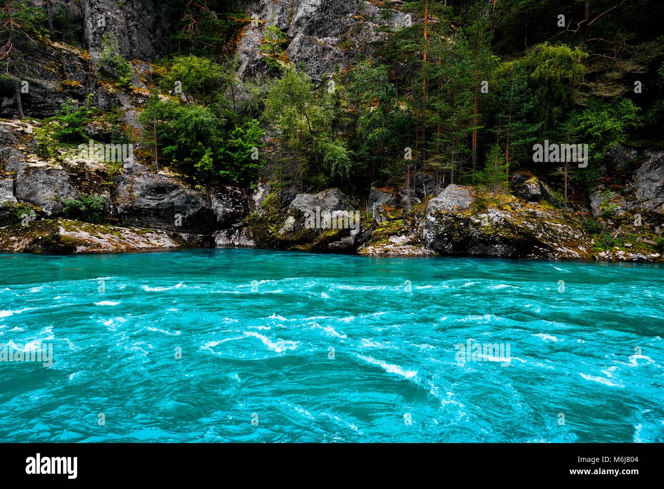 Image of a blue turquoise river with clear water and harsh cliffs and ...