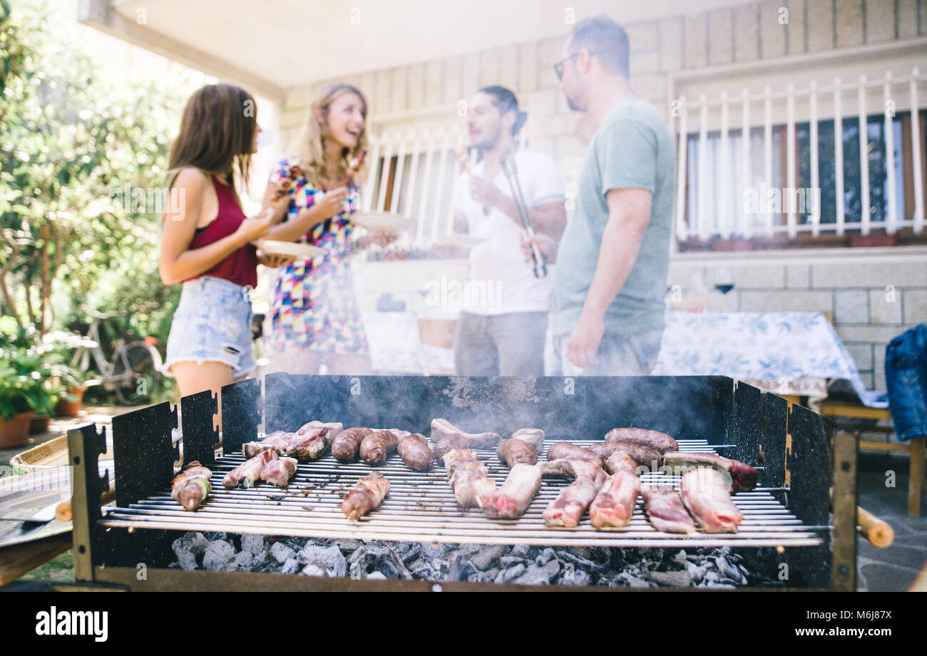 Group of friends making barbeque in the backyard. concept about good ...
