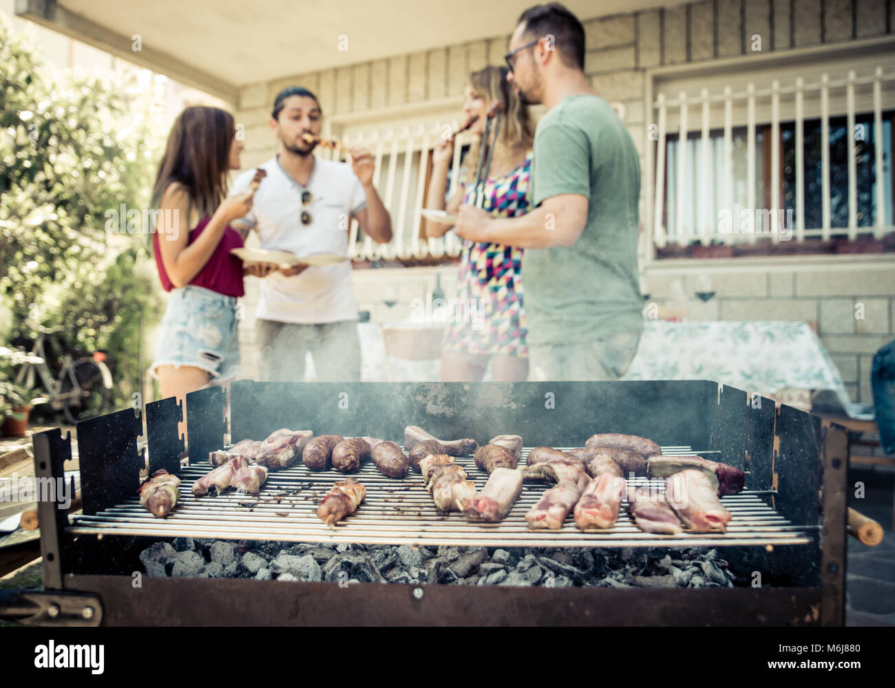 Group of friends making barbeque in the backyard. concept about good ...