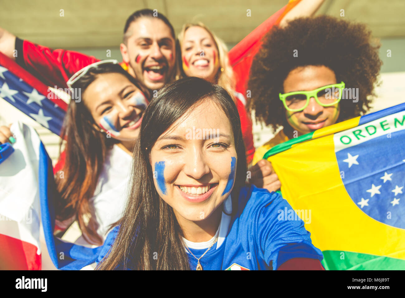 Group of mixed football fans taking selfies Stock Photo - Alamy