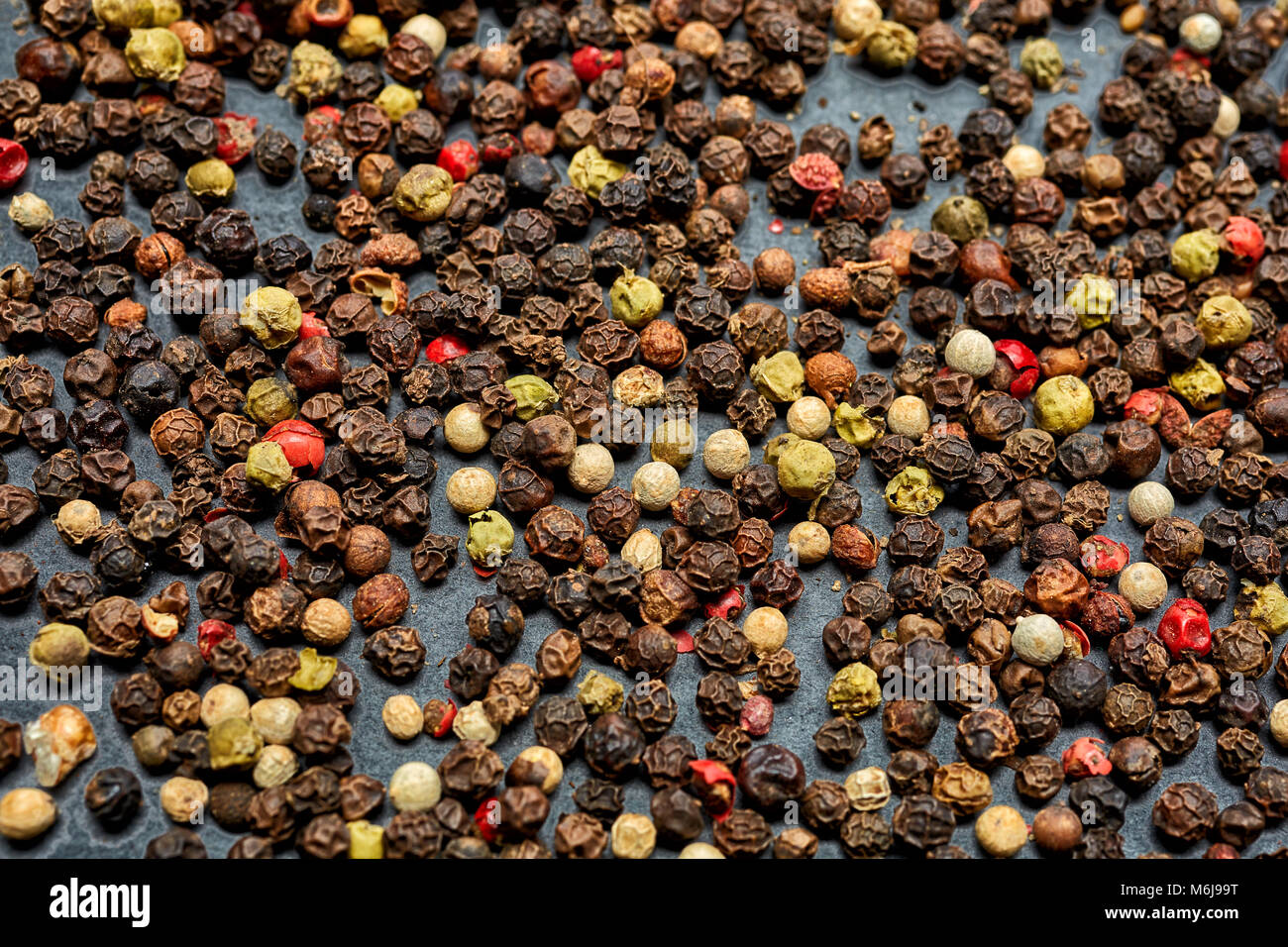 Different types of pepper. Mix of grind black pepper and allspice seeds ...