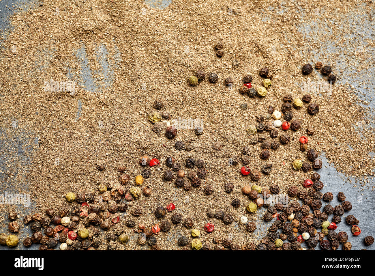 Different types of pepper. Mix of grind black pepper and allspice seeds ...
