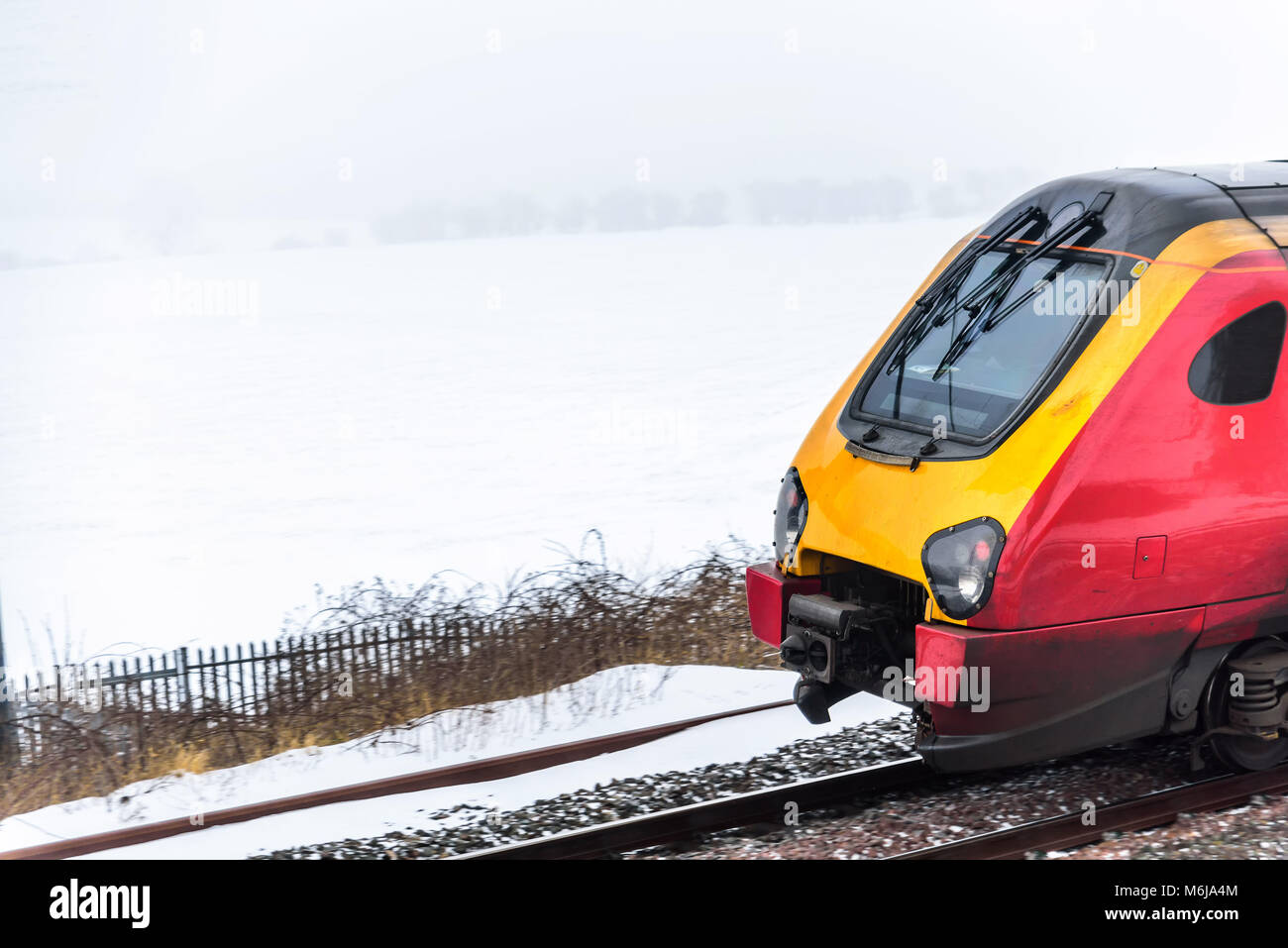 Cloudy foggy winter day view of Train on UK Railroad in England. Emma ...