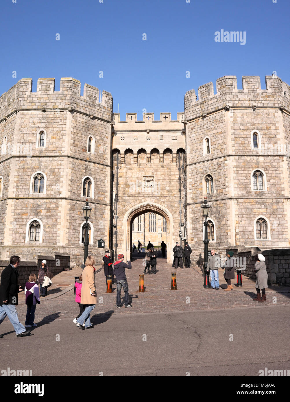 The Entrance to Windsor Castle in England with sightseers walking by ...