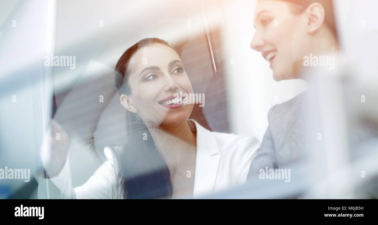 behind the glass.colleagues sitting at your Desk Stock Photo - Alamy