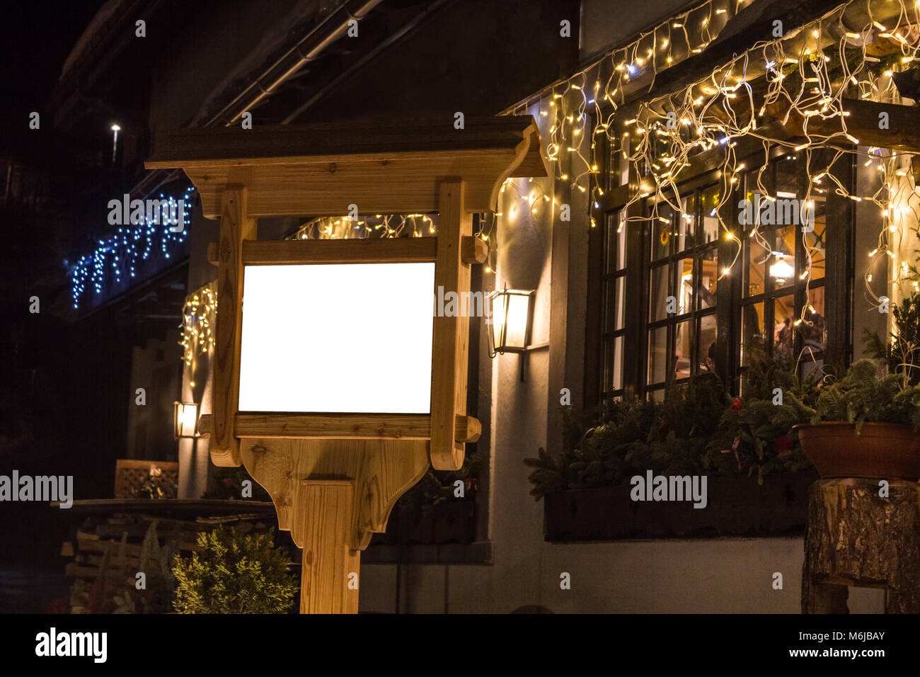 Wooden Resturant Sign Outside Night Lights Stock Photo - Alamy