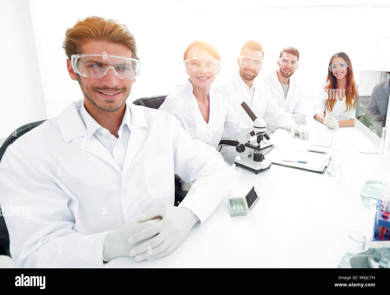 Male scientist and the team in the lab Stock Photo - Alamy