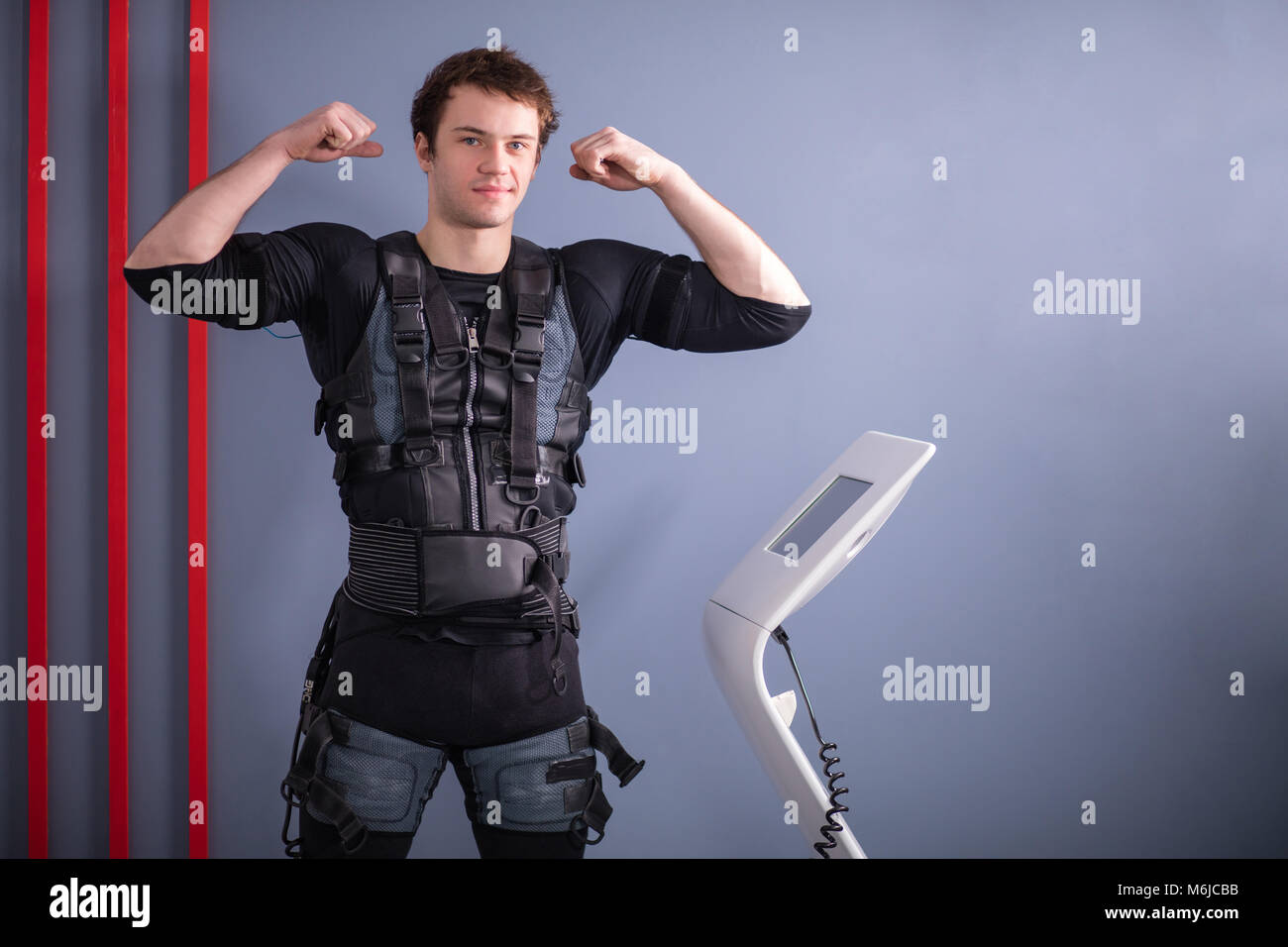 man near EMS machine, muscle stimulation, showing biceps Stock Photo ...