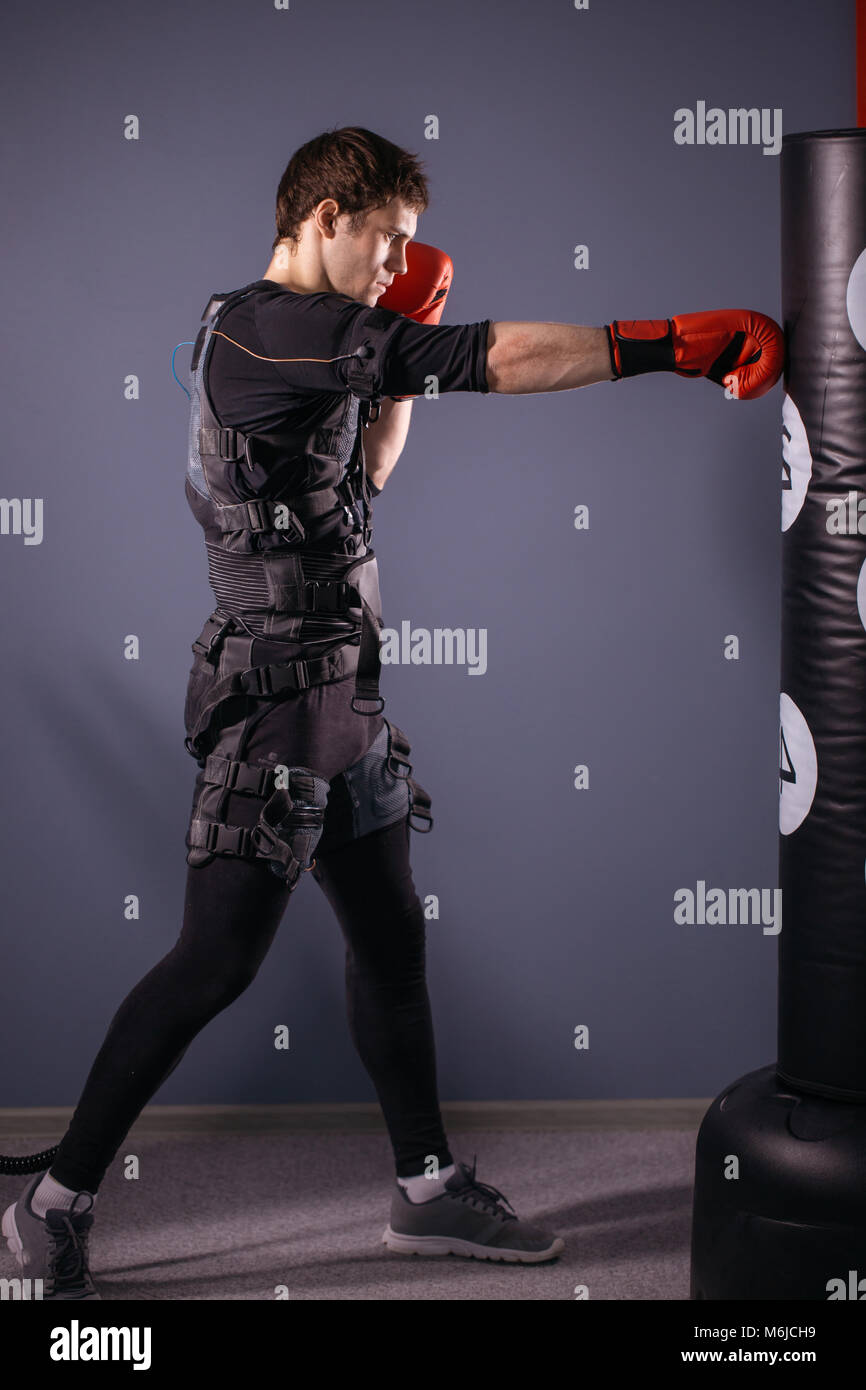 man in boxing gloves during training. boxer in suit of electric ...
