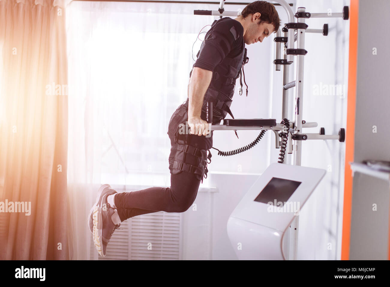 EMS male working out, doing push ups. man doing triceps dips on ...