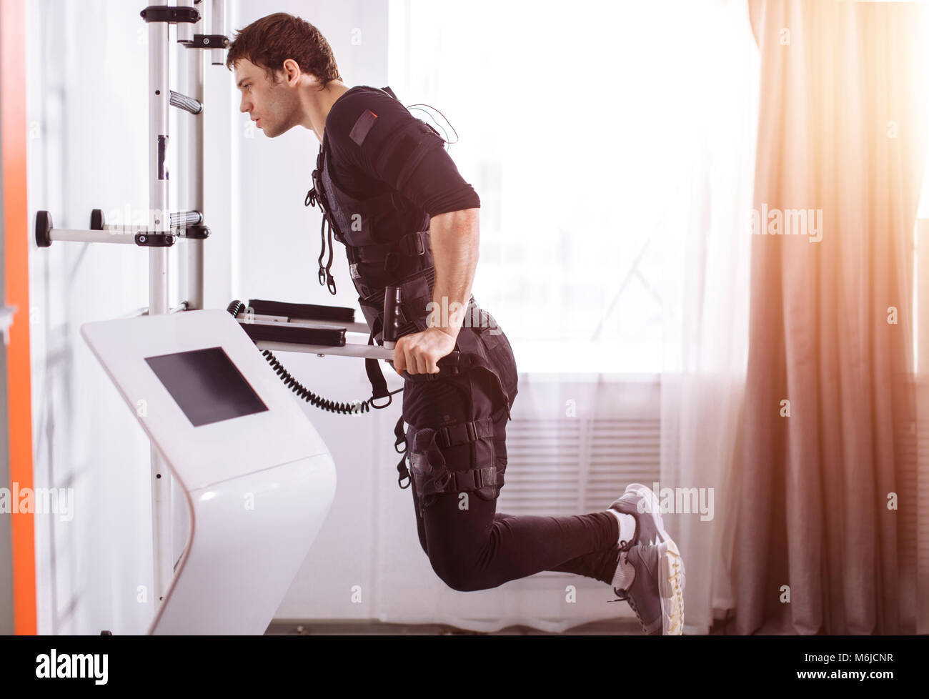 EMS male working out, doing push ups. man doing triceps dips on ...