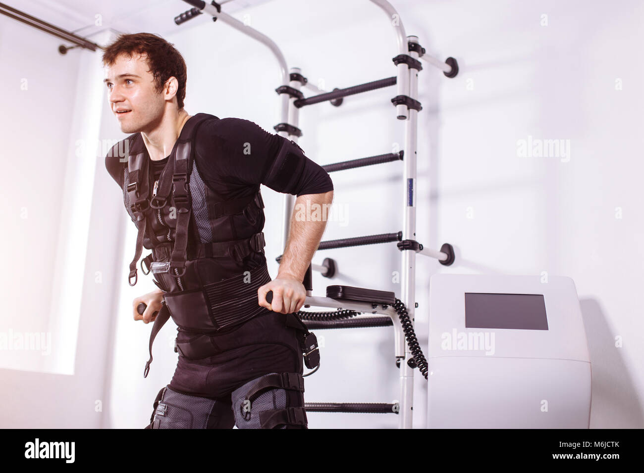 EMS male working out, doing push ups. man doing triceps dips on ...