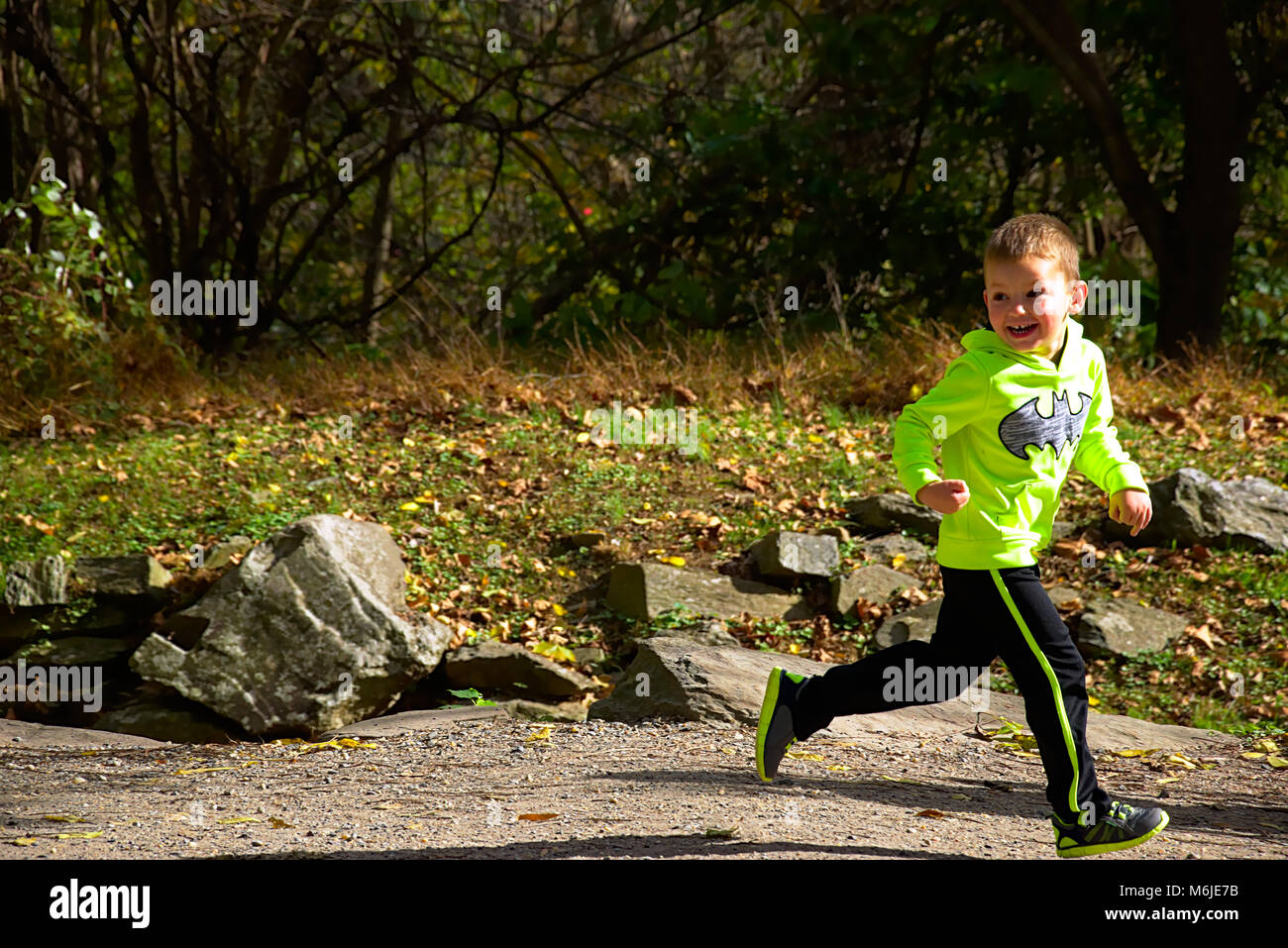 kid laughing and running looking back Stock Photo - Alamy