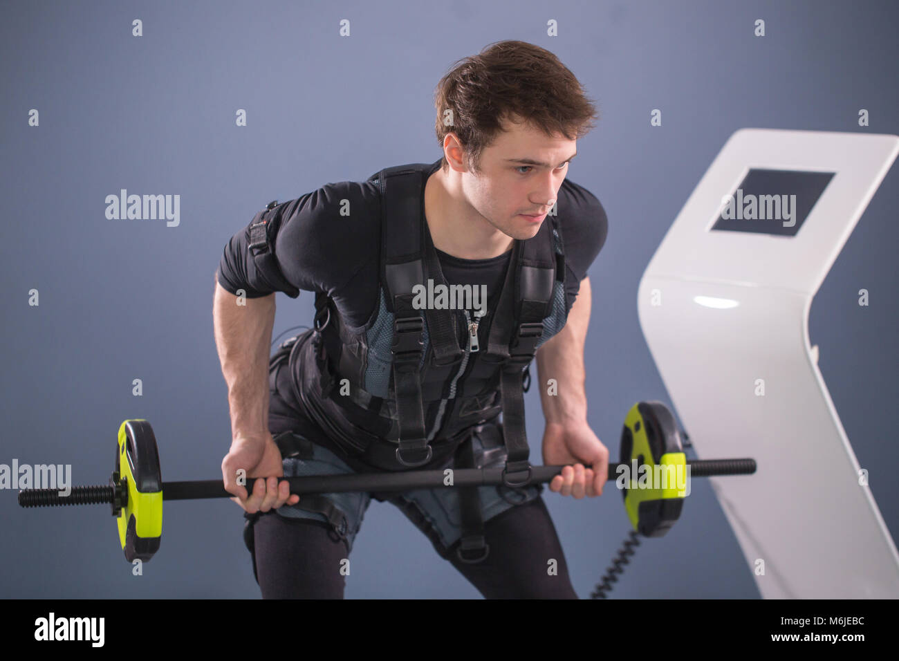 Man working out EMS training with barbell closeup, power pose Stock ...